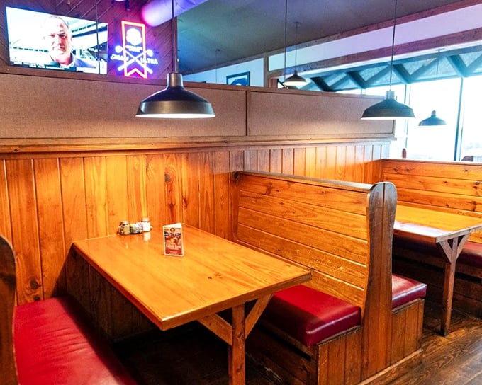 Those wooden booths aren't just seating—they're conversation nooks where friendships deepen and food memories are made over sizzling plates.