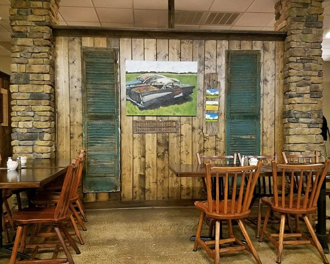 Rustic wood paneling, vintage shutters, and classic chairs create a dining space that feels like Sunday dinner at a beloved relative's lake house.