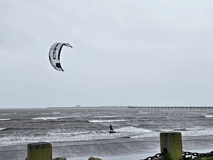 Even on gray days, adventure seekers find their thrills. This kitesurfer isn't deterred by the moody Northern California weather – they're embracing it.