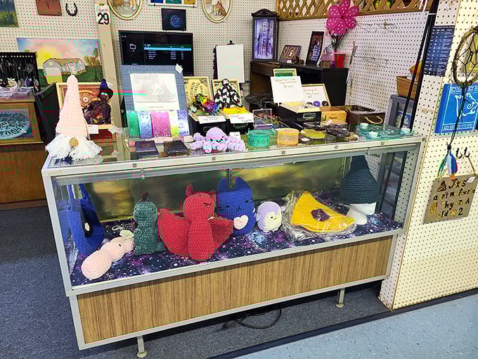 Handcrafted knitted creatures peek out from display cases, each one carrying the unmistakable charm of items made with patience and skill.