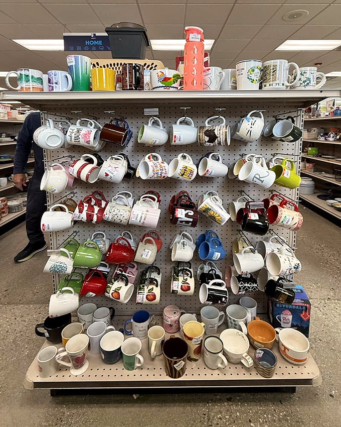 Mug heaven! A pegboard paradise of morning possibilities. Each handle represents someone's abandoned caffeine vessel—and your potential new favorite coffee companion.