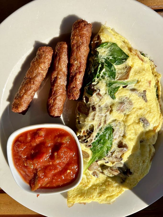 An omelet that Julia Child would applaud, accompanied by sausage links that actually snap when bitten. That homemade salsa adds just the right kick.