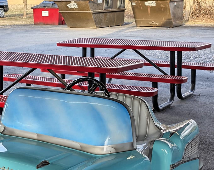 Red picnic tables and vintage cars—the perfect pairing, like fries and ketchup. Some dining rooms have chandeliers; this one has Pennsylvania sky.