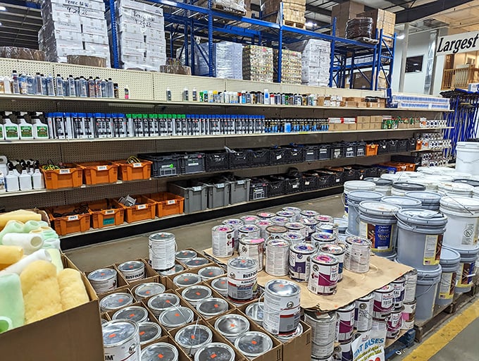Paint paradise for the home improvement enthusiast. Those stacked buckets contain more than color—they hold the potential for transformation at bargain basement prices.
