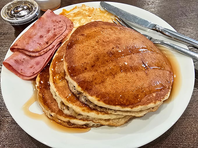 These pancakes aren't messing around—fluffy, golden-brown discs of comfort that make Monday mornings slightly less offensive.