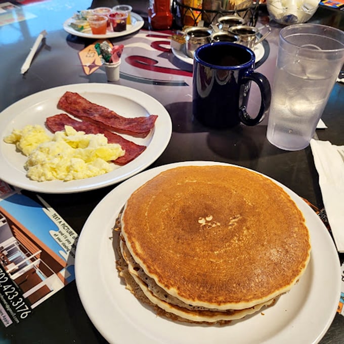 Pancakes the size of vinyl records, stacked high enough to cast a shadow – the breakfast equivalent of hitting a jackpot on your first pull.