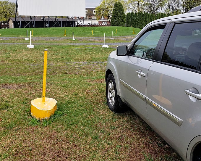 Yellow parking markers guide you to the perfect spot – not too close, not too far from cinematic glory.