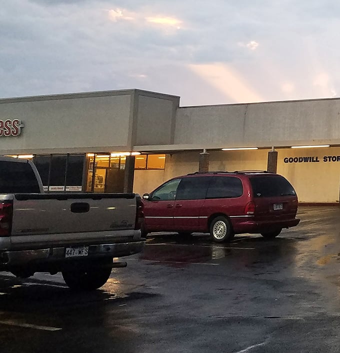 Even the parking lot tells a story – rain-slicked asphalt reflecting the glow of possibility from within those humble walls.