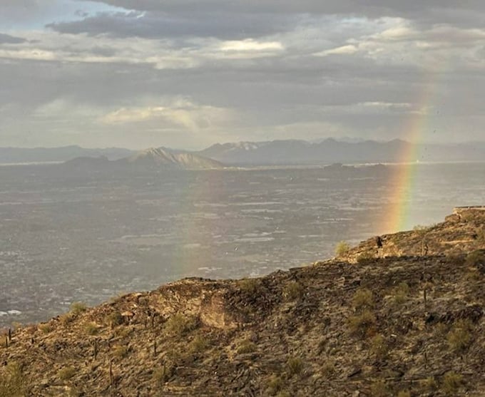 Nature's own "well done" certificate – a rainbow arcs across the valley, as if the universe is congratulating you for making the drive up.
