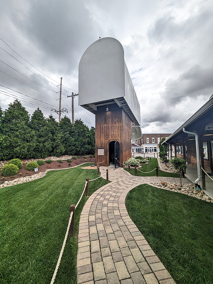 From behind, the mailbox's impressive engineering reveals itself—sturdy wooden supports and metal framework holding postal dreams aloft against Illinois skies.