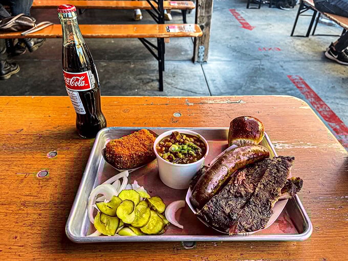 Meat and metal tray – a timeless romance. This BBQ plate with ribs, sausage, and pickles is San Francisco's answer to Texas dreams.
