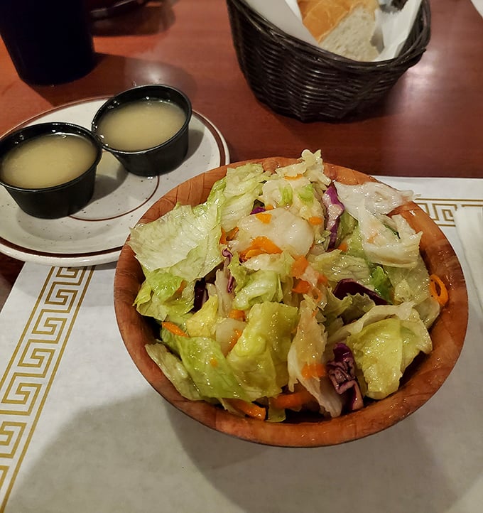 Fresh, crisp house salad served in a wooden bowl with dressing on the side—the perfect light counterpoint to barbecue indulgence.