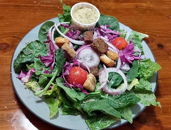 A salad that actually excites—vibrant greens, purple cabbage, and croutons that weren't born in a factory. Eating healthy never looked so good.