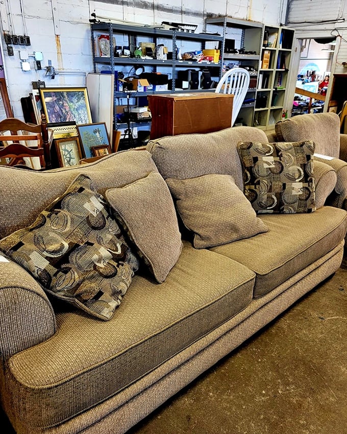 The couch equivalent of a warm hug, complete with throw pillows. Someone's living room is about to get significantly more comfortable for pennies on the dollar.
