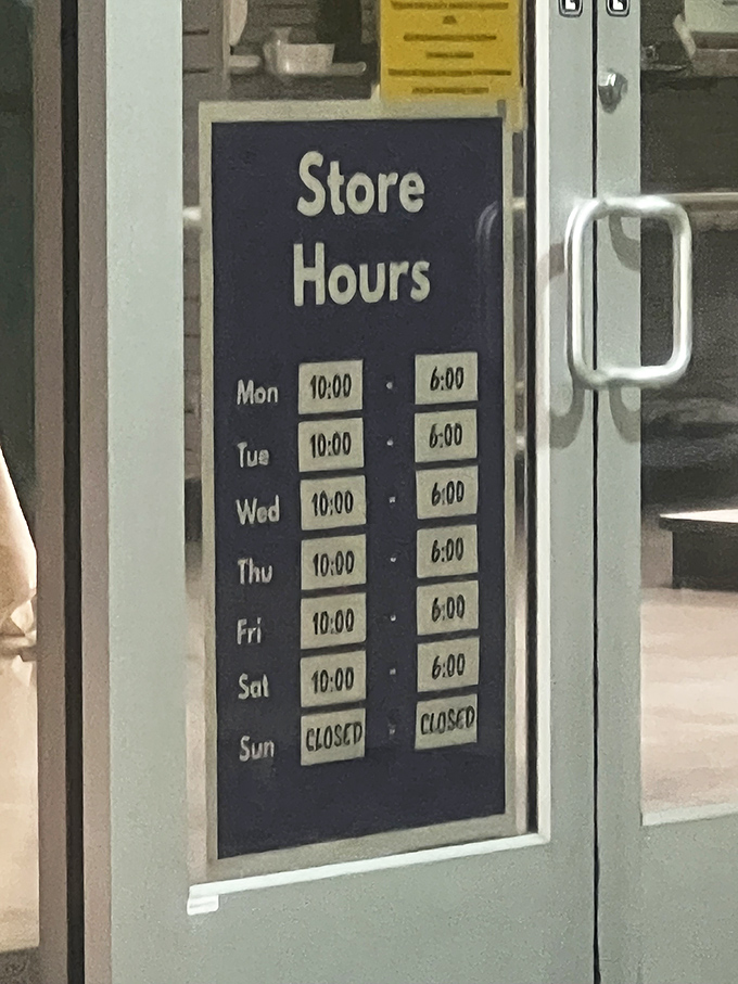 The store hours sign—a beacon of organization in a chaotic world. Six days a week to hunt for treasures, Sundays reserved for counting your savings.