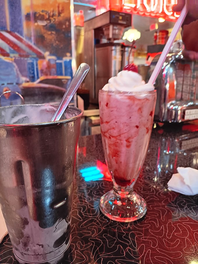 Milkshakes thick enough to require serious straw commitment. That strawberry creation isn't a beverage—it's dessert with a straw as a serving suggestion.