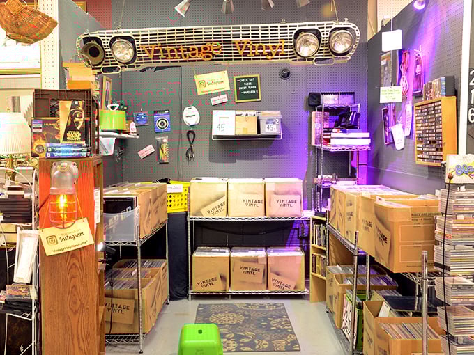 Vinyl paradise! That vintage car grille watching over record boxes is the perfect guardian for musical memories from decades past.