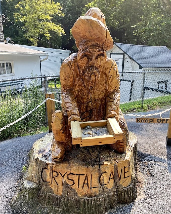 A wooden wizard guards his crystal treasure – this carved statue captures the magical feeling of discovering underground wonders.