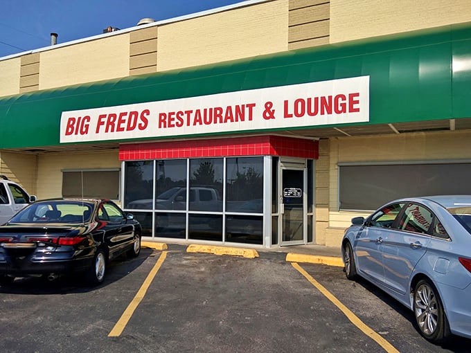 Big Fred's green and red sign beckons like a lighthouse for pizza lovers lost in ordinary dining.