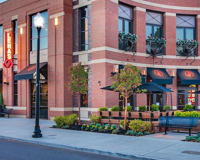 Lena's elegant brick building and lush patio plants create an oasis where pizza dreams come true. Pinch yourself – it's real!