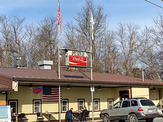 Mom's Place flies the flag high above its humble exterior. That Coca-Cola sign has been guiding hungry travelers for decades.