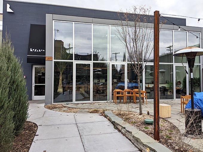This sleek, modern façade houses ancient pizza wisdom – where fire, dough, and time create magic that no microwave could ever replicate.