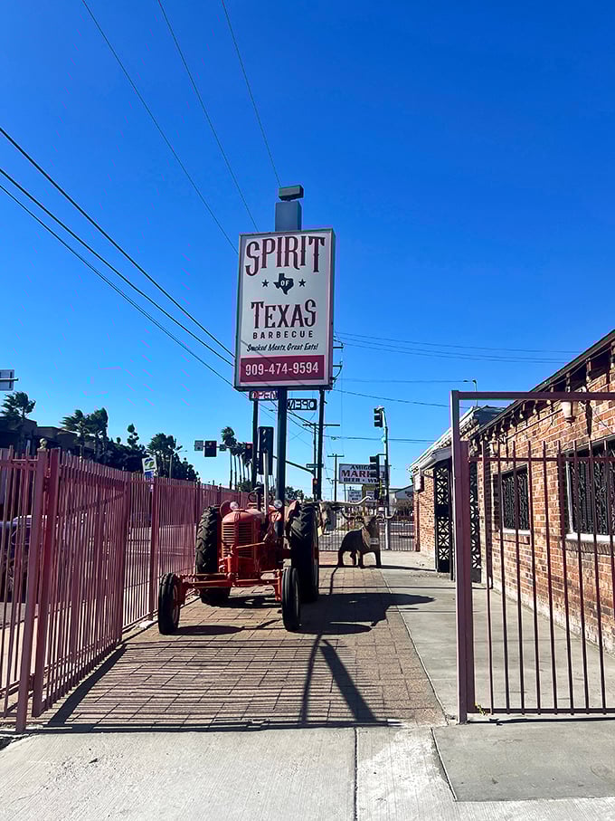 Spirit of Texas announces itself with a no-nonsense sign and vintage tractor. This is where serious BBQ pilgrims come to worship at the altar of smoke.