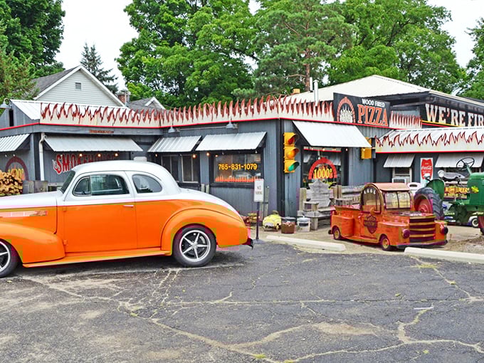 Vintage fire truck and flames announce this pizza place means business about authentic wood-fired cooking techniques.