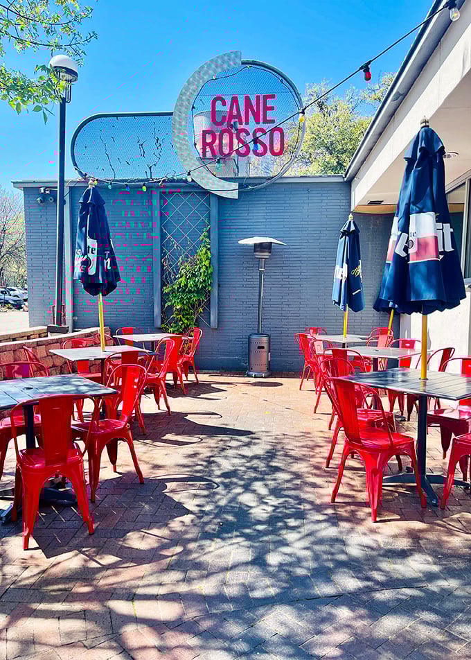 Red chairs dot Cane Rosso's inviting patio. Fort Worth pizza lovers know this is where Neapolitan magic happens under Texas skies.