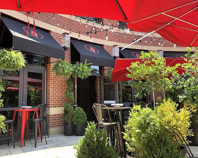 Those red umbrellas at Lena's aren't just for shade – they're signaling to pizza lovers that something special awaits below.