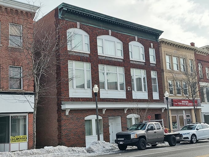 Historic brick facades and snow-dusted sidewalks capture the quiet charm of Southbridge’s Main Street in winter.