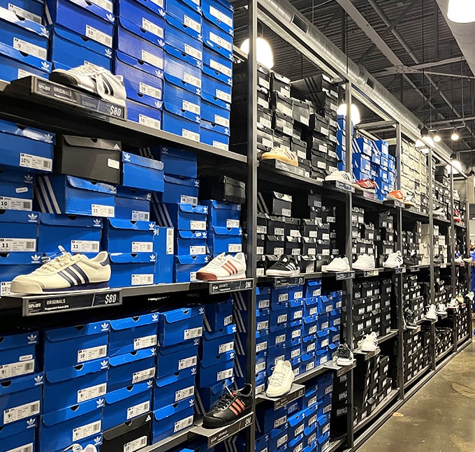 The Adidas outlet's wall of blue boxes holds footwear dreams at dream prices. Sneakerheads, prepare your credit cards accordingly.