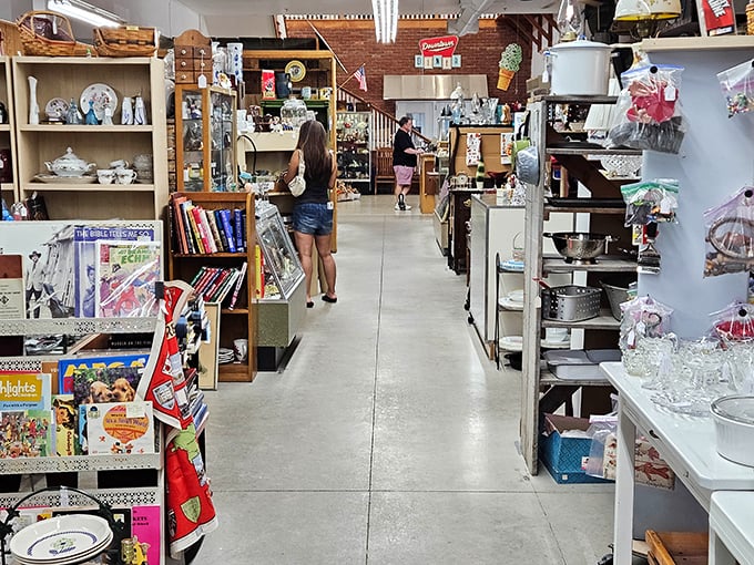 The perfect antiquing aisle – narrow enough to feel like discovery, wide enough to prevent the dreaded "bull in a china shop" moments that haunt cautious browsers.