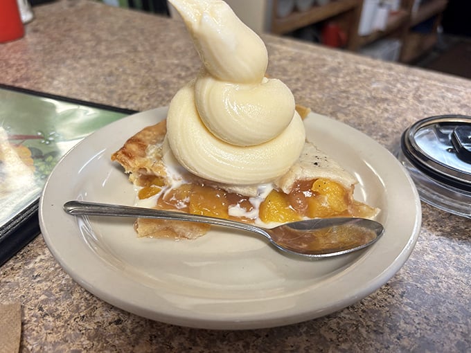 Apple pie à la mode with ice cream piled high like a mountain of vanilla dreams – proof that sometimes the classics really are unbeatable.