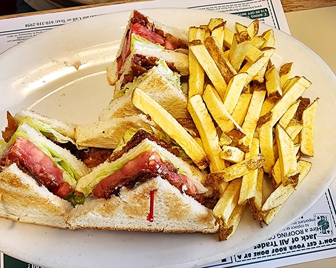 The BLT club sandwich towers like a delicious skyscraper, proving that breakfast isn't the only game in town.