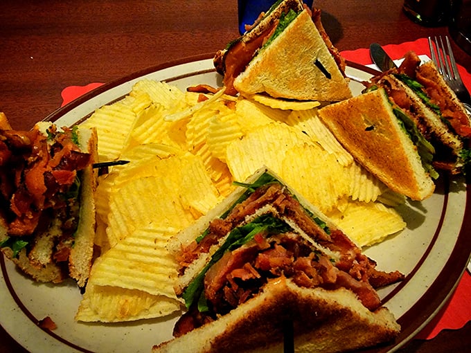 This club sandwich isn't messing around—layers of bacon, fresh vegetables, and toasted bread create the architectural marvel of lunch options.