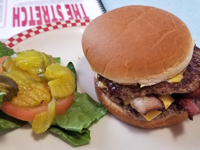 A burger that requires jaw exercises before attempting. Those pickles aren't just garnish—they're essential supporting characters in this meaty drama.