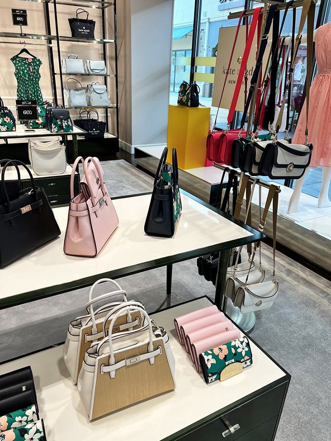 Designer handbag heaven awaits at Kate Spade, where pastel dreams and structured leather temptations line the shelves at delightful discounts.