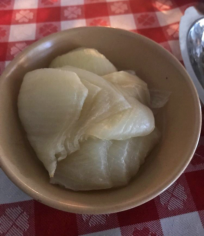 The humble onion, transformed. These tender white petals have been coaxed into submission through slow cooking – a steakhouse delicacy.