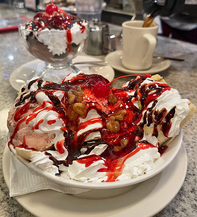 This isn't just a banana split—it's a dessert carnival with whipped cream mountains, syrup rivers, and a cherry on top playing ringmaster.