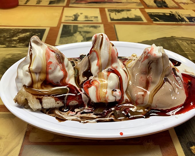 This banana split isn't just dessert, it's an event – three peaks of ice cream drizzled with enough toppings to make your dentist weep.