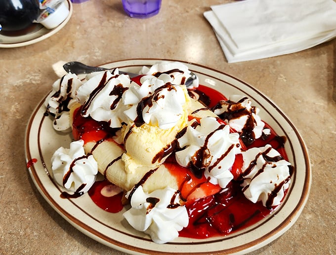 This banana split isn't just dessert—it's performance art with whipped cream standing ovations and chocolate drizzle encore calls.