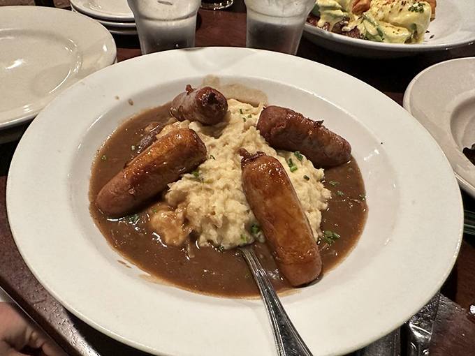 Bangers and Mash – where plump sausages lounge on creamy potato islands in a sea of savory gravy. Comfort food that hugs you from the inside out.
