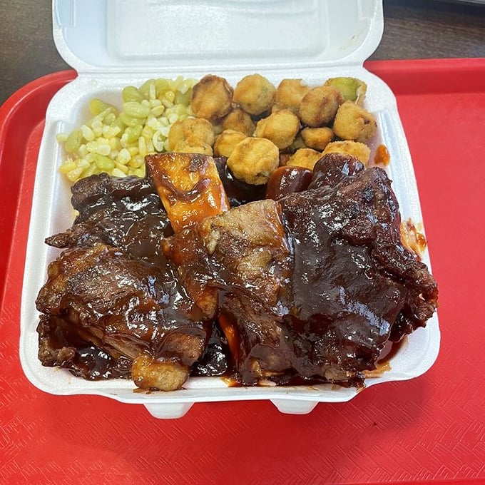 Barbecue ribs glistening with sauce that should be bottled and sold as cologne. The meat doesn't fall off the bone—it leaps willingly onto your fork.