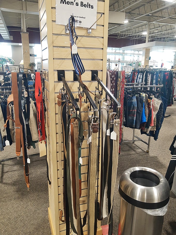 The belt display—where leather strips hang like trophies, waiting to perform the heroic duty of keeping pants where they belong.