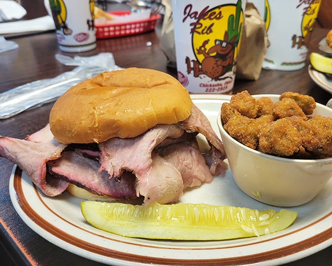 The sandwich that launched a thousand road trips—tender meat piled high on a soft bun with crispy sides for textural contrast.