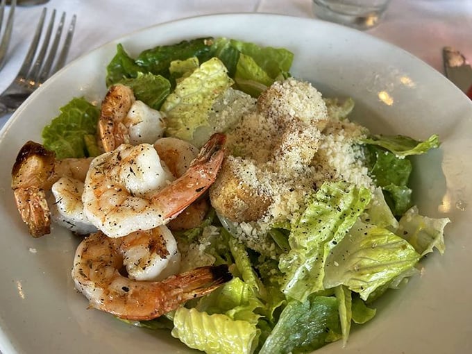 Sometimes simplicity wins – perfectly grilled shrimp perched atop crisp romaine, a Caesar salad that proves classics become classics for good reason.