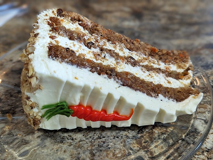 This isn't just carrot cake—it's an architectural marvel of moist layers, cream cheese frosting, and that adorable carrot decoration sealing the deal.