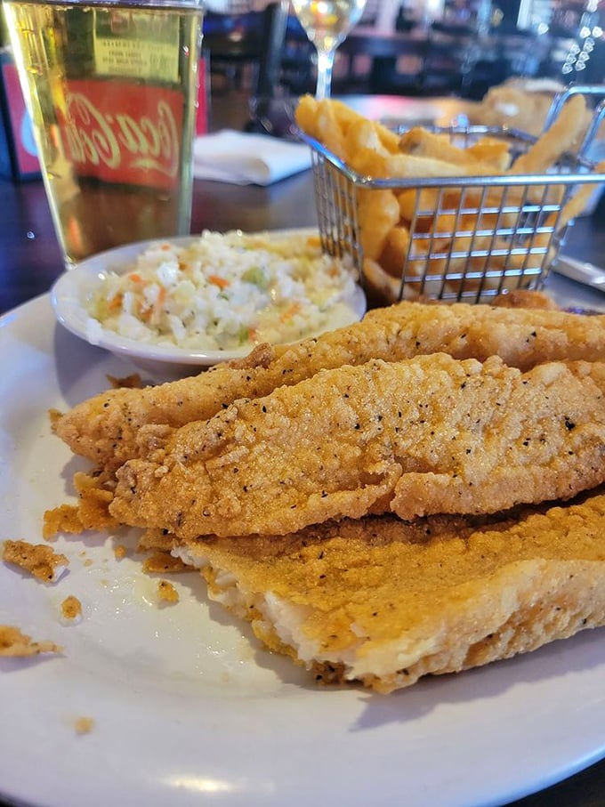 The catfish dinner comes with coleslaw and fries in a wire basket—a trio that's been making Midwesterners smile since before Netflix existed.