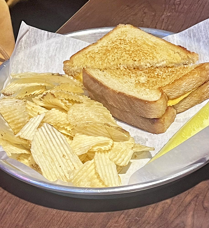 The humble grilled cheese, elevated to art form. Between those perfectly toasted slices lies the comfort food equivalent of a warm hug.